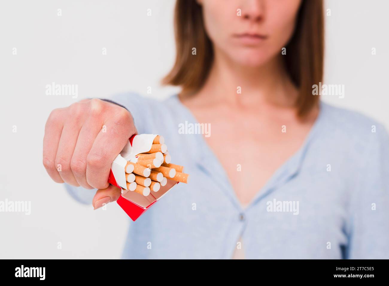 Woman s hand holding packet cigarettes Stock Photo - Alamy