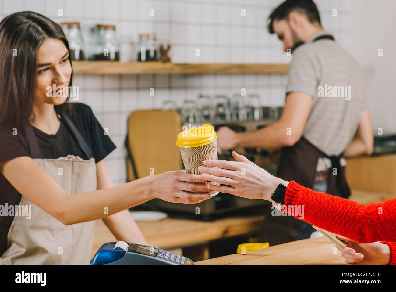 Barista giving drink customer Stock Photo - Alamy