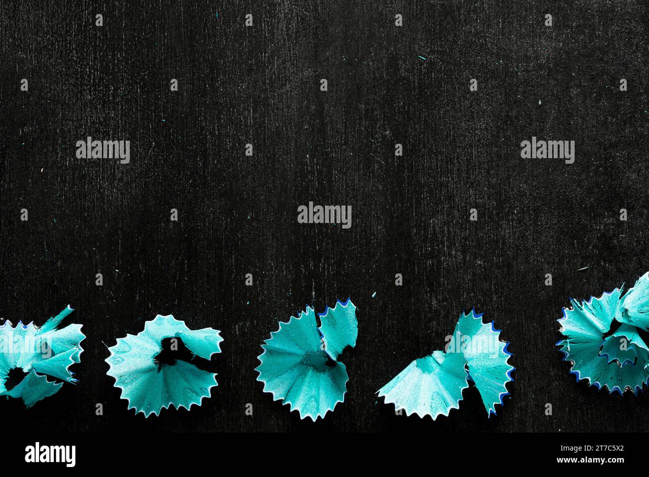 Blue pencil chips black desk Stock Photo - Alamy