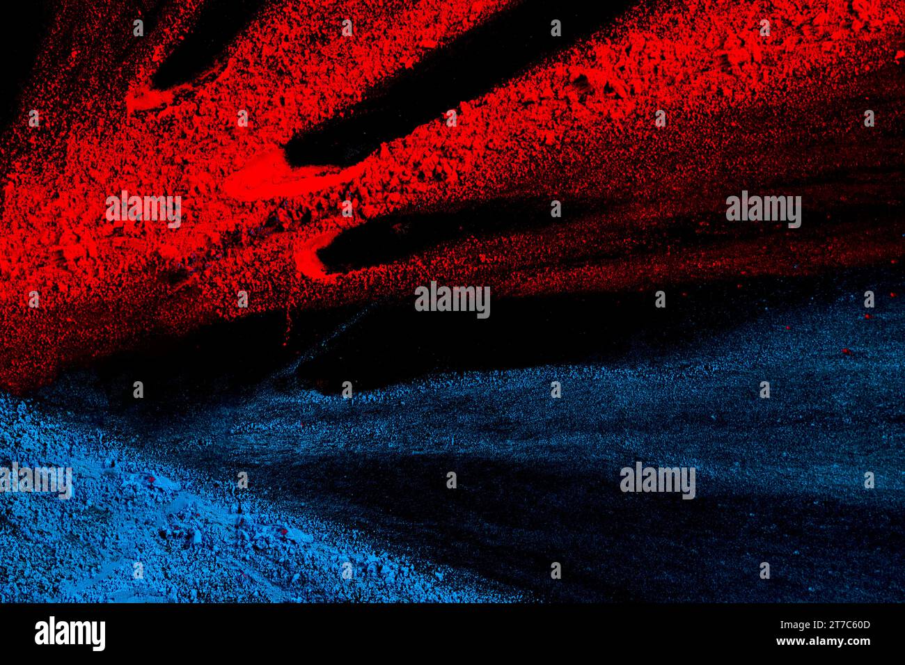Bright red blue holi powder against black surface Stock Photo - Alamy