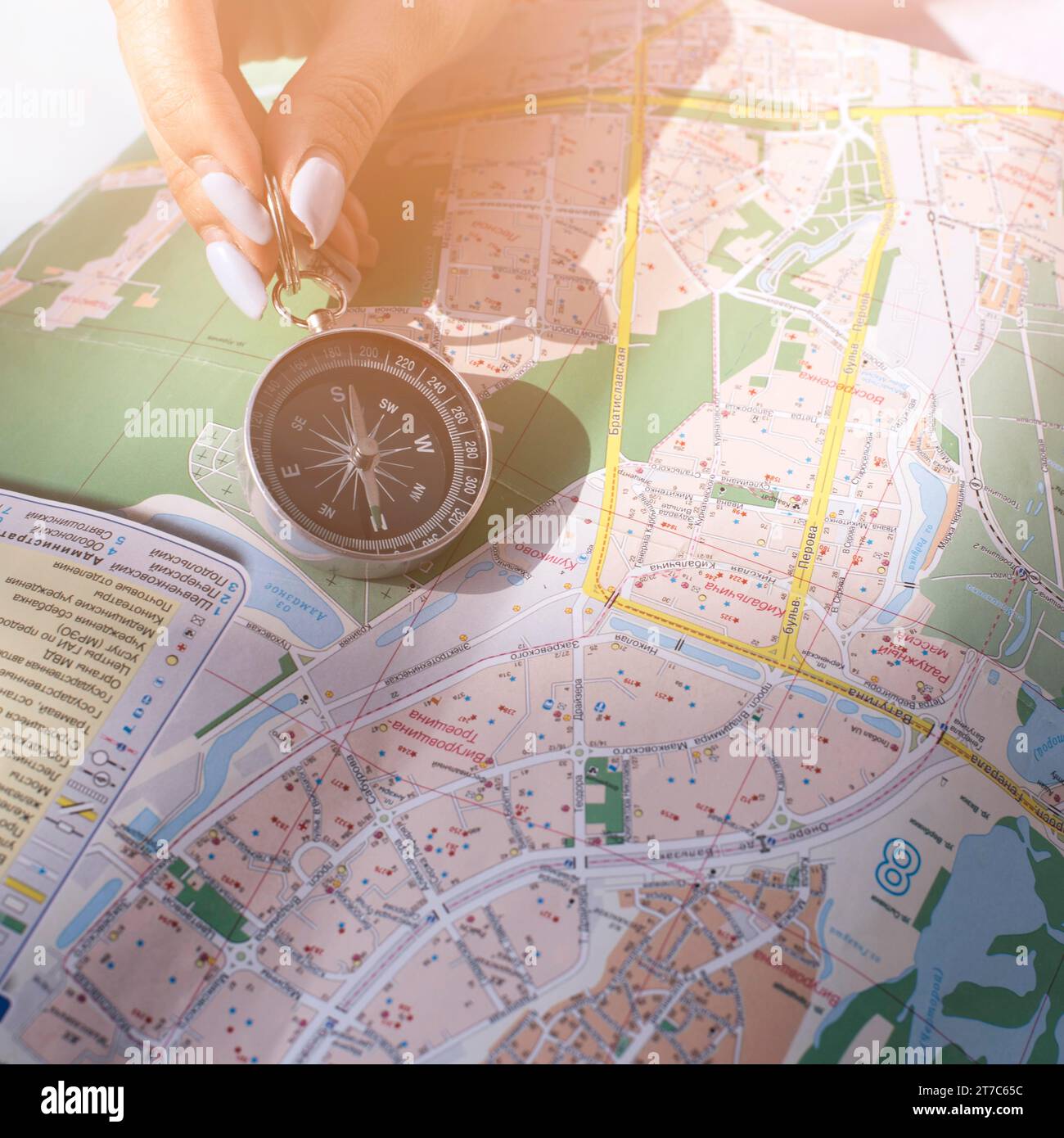 Close up female s hand holding navigational compass map Stock Photo - Alamy