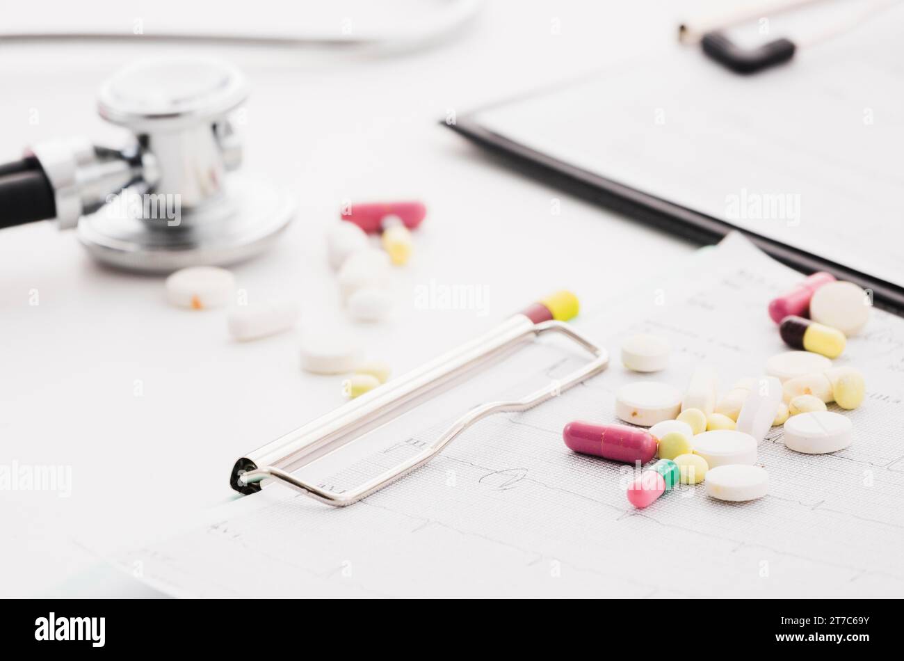 Colorful pills ecg graph stethoscope white background Stock Photo - Alamy