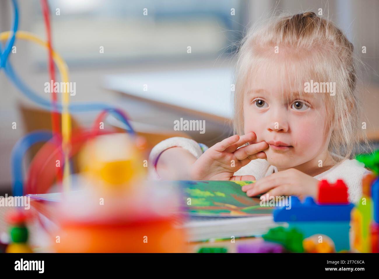 Cute preschooler girl looking away Stock Photo - Alamy