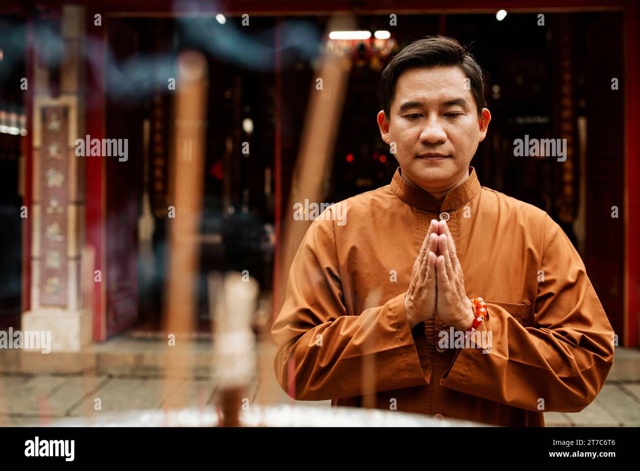 Front view man praying temple with incense Stock Photo - Alamy