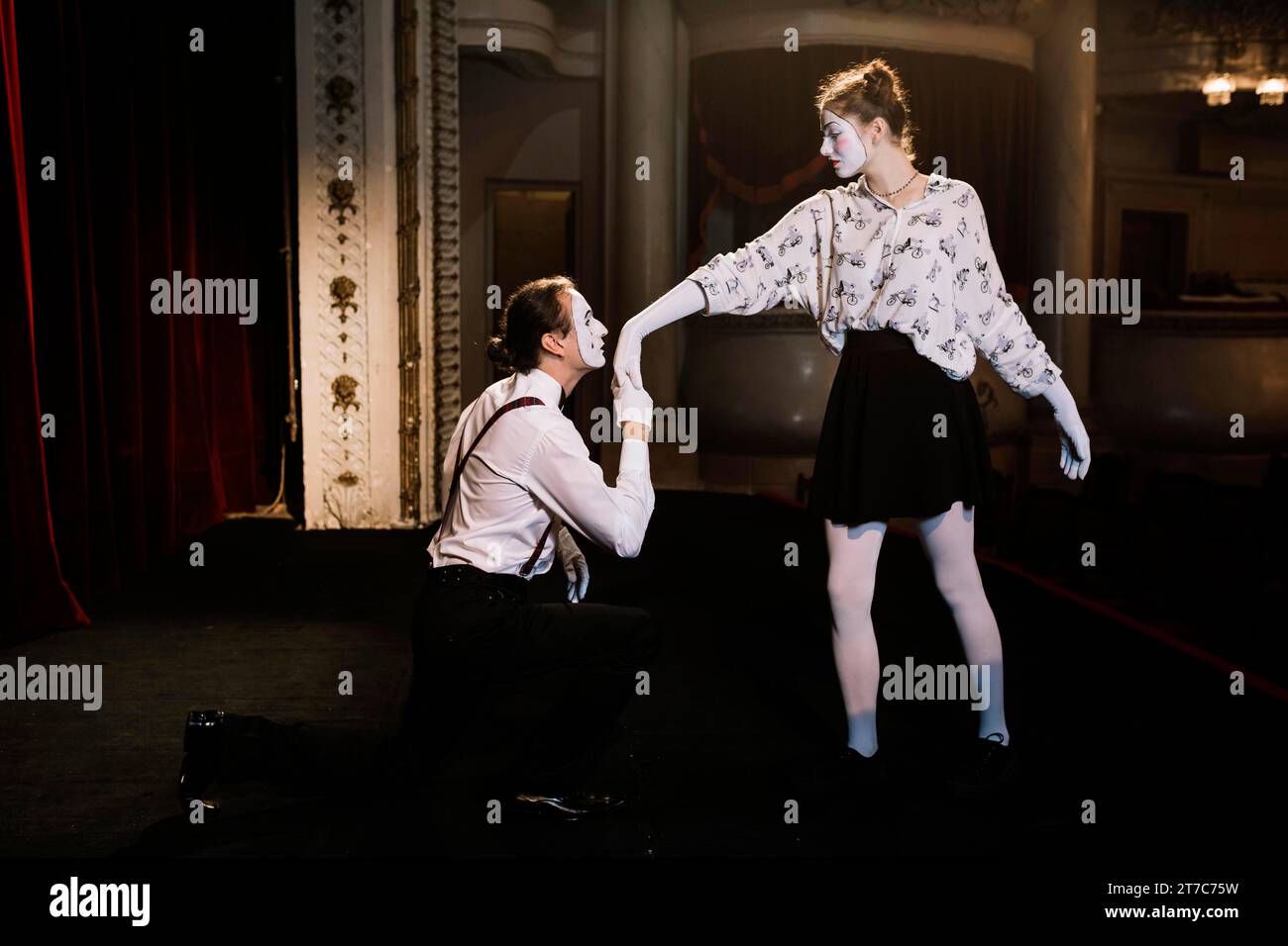 Male mime artist kissing female mime s hand stage Stock Photo - Alamy