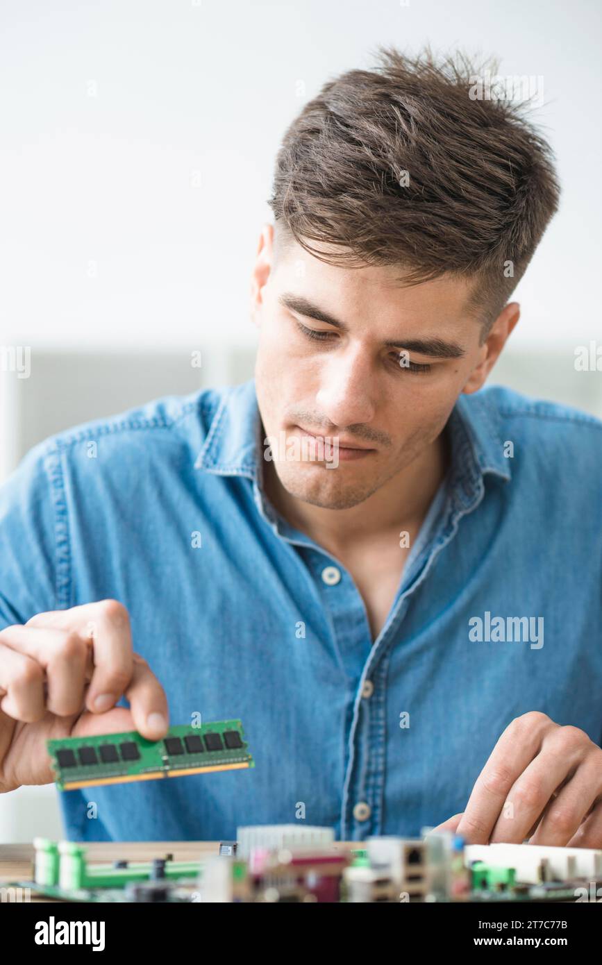 Male technician installing ram computer motherboard Stock Photo - Alamy
