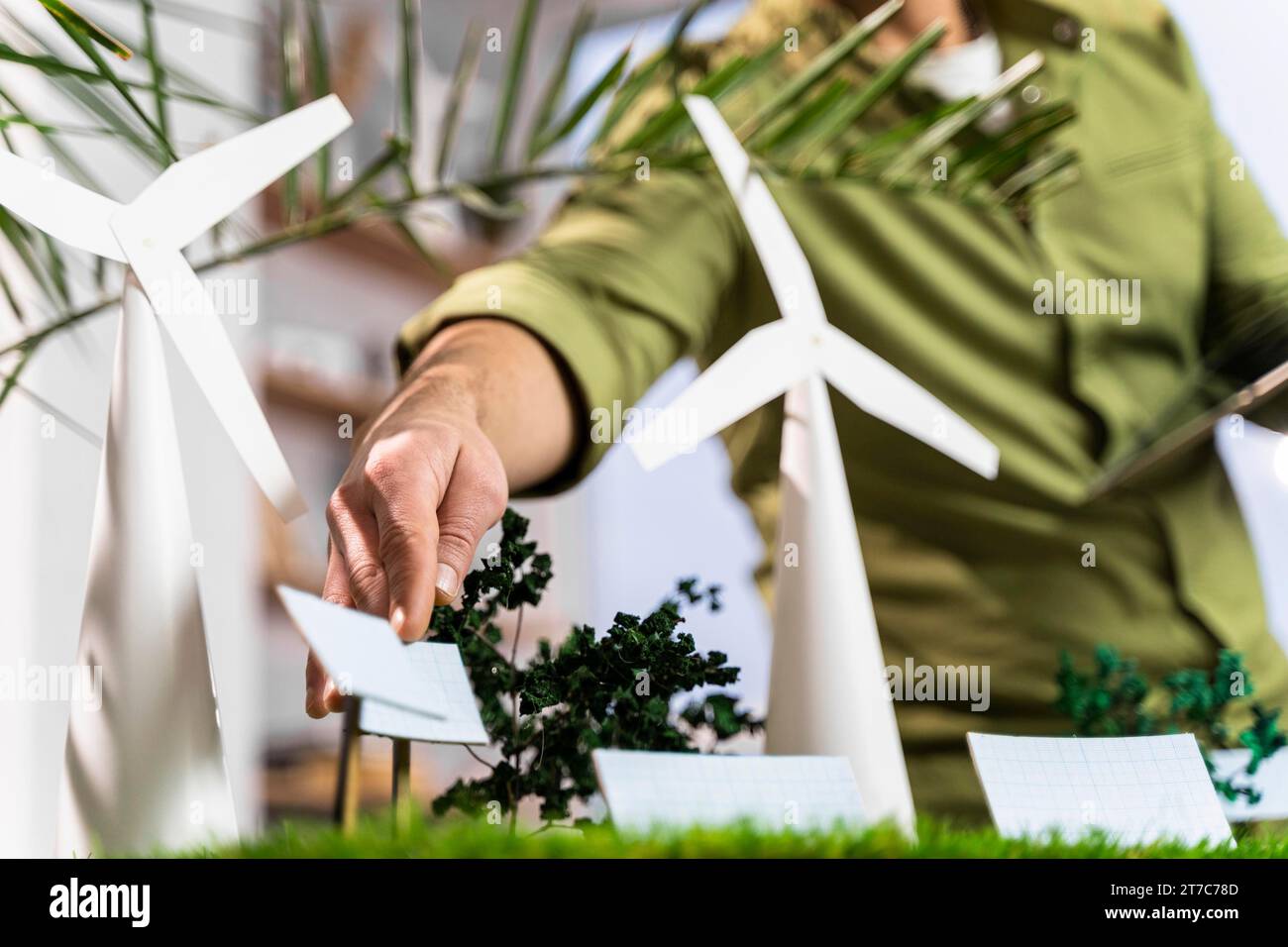 Man fixing up eco friendly wind power project layout Stock Photo - Alamy