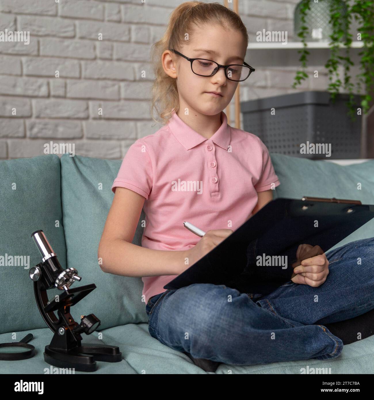 Medium shot girl taking notes Stock Photo - Alamy