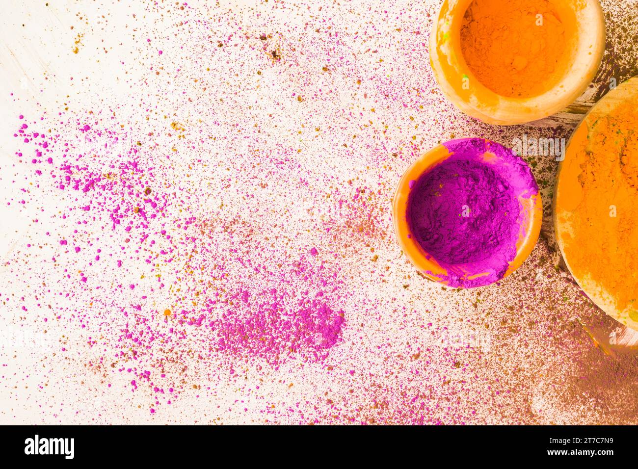Pink yellow holi powder bowl with stained white background Stock Photo ...