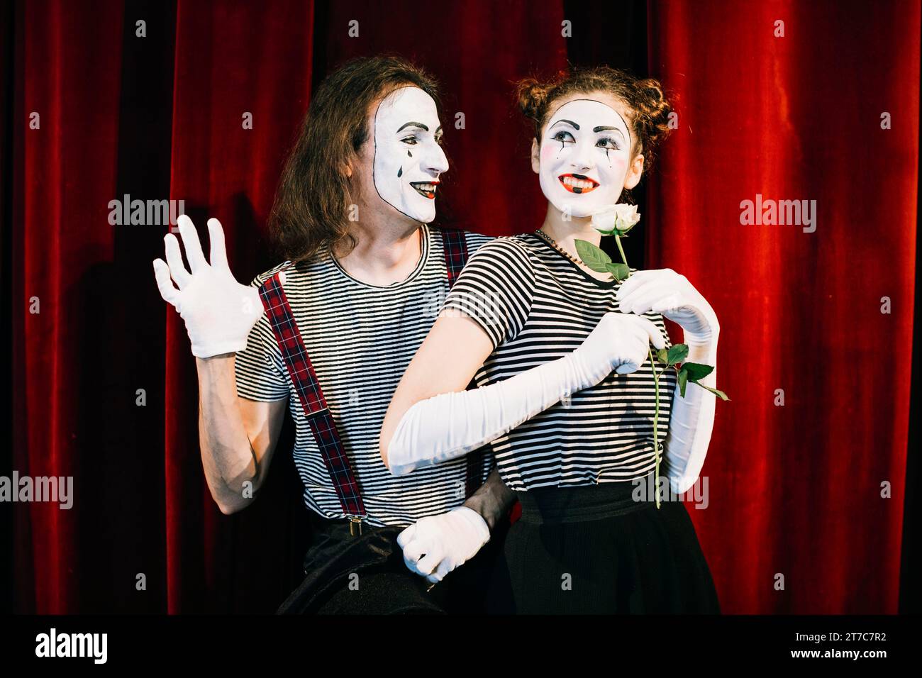 Portrait two happy mime artist front red curtain Stock Photo - Alamy