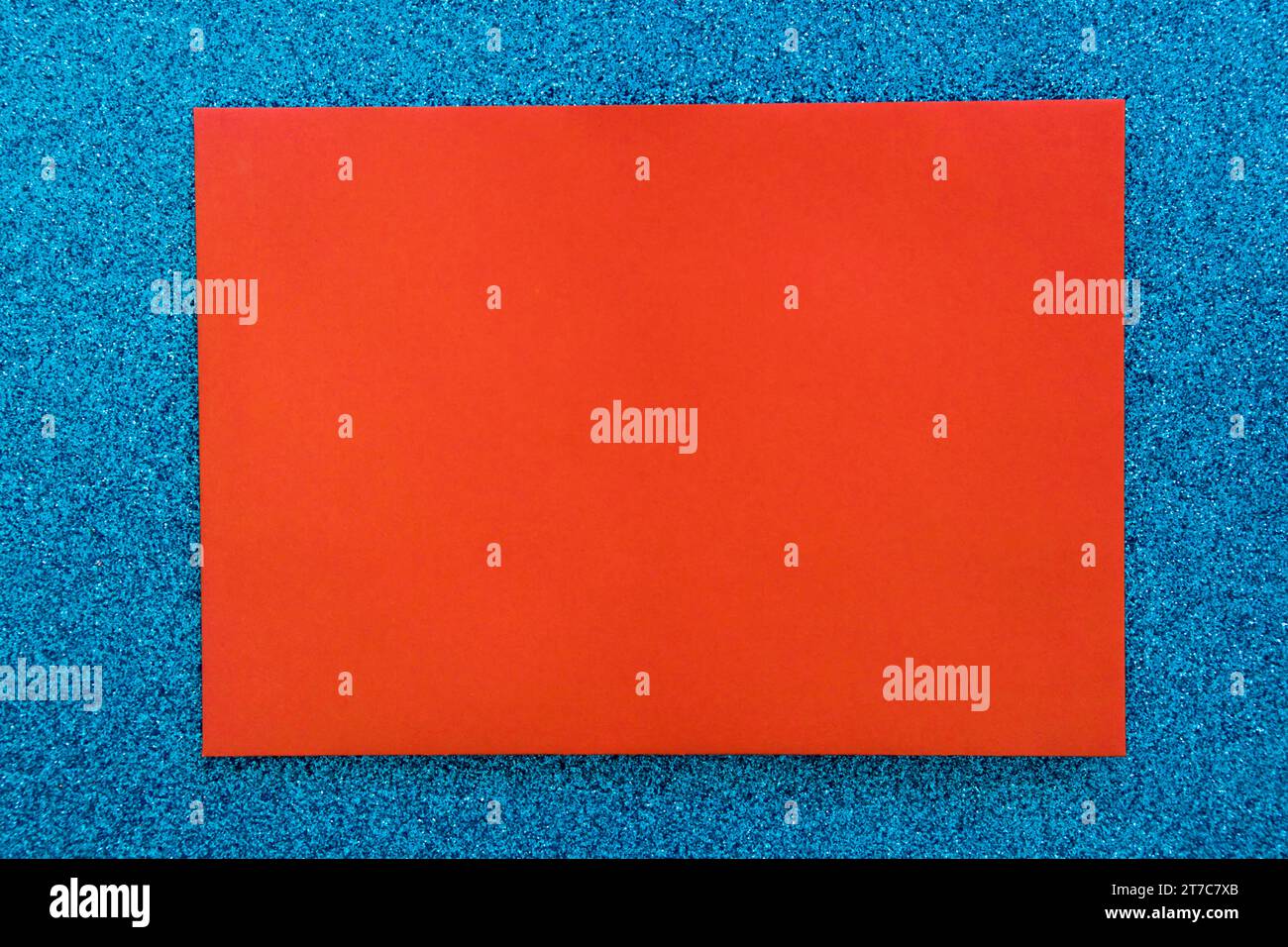 Red cardboard paper blue glitter background Stock Photo - Alamy