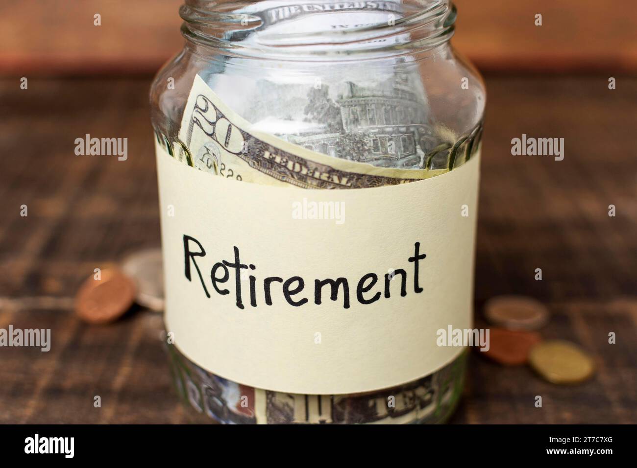 Retirement label jar filled with money Stock Photo - Alamy