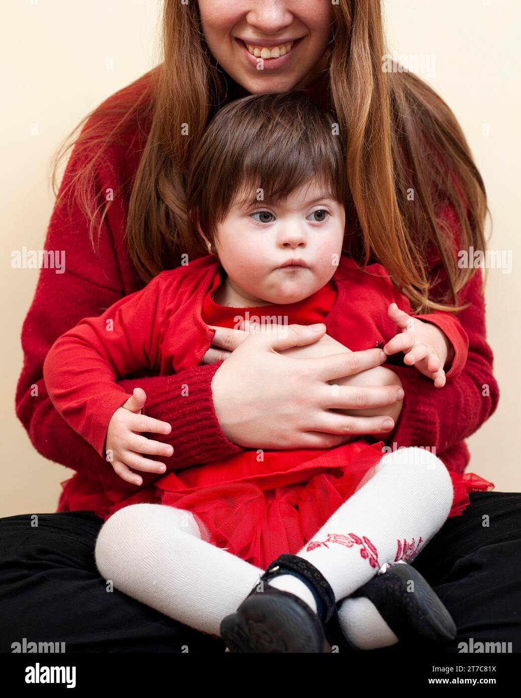 Smiley woman holding child with down syndrome Stock Photo - Alamy