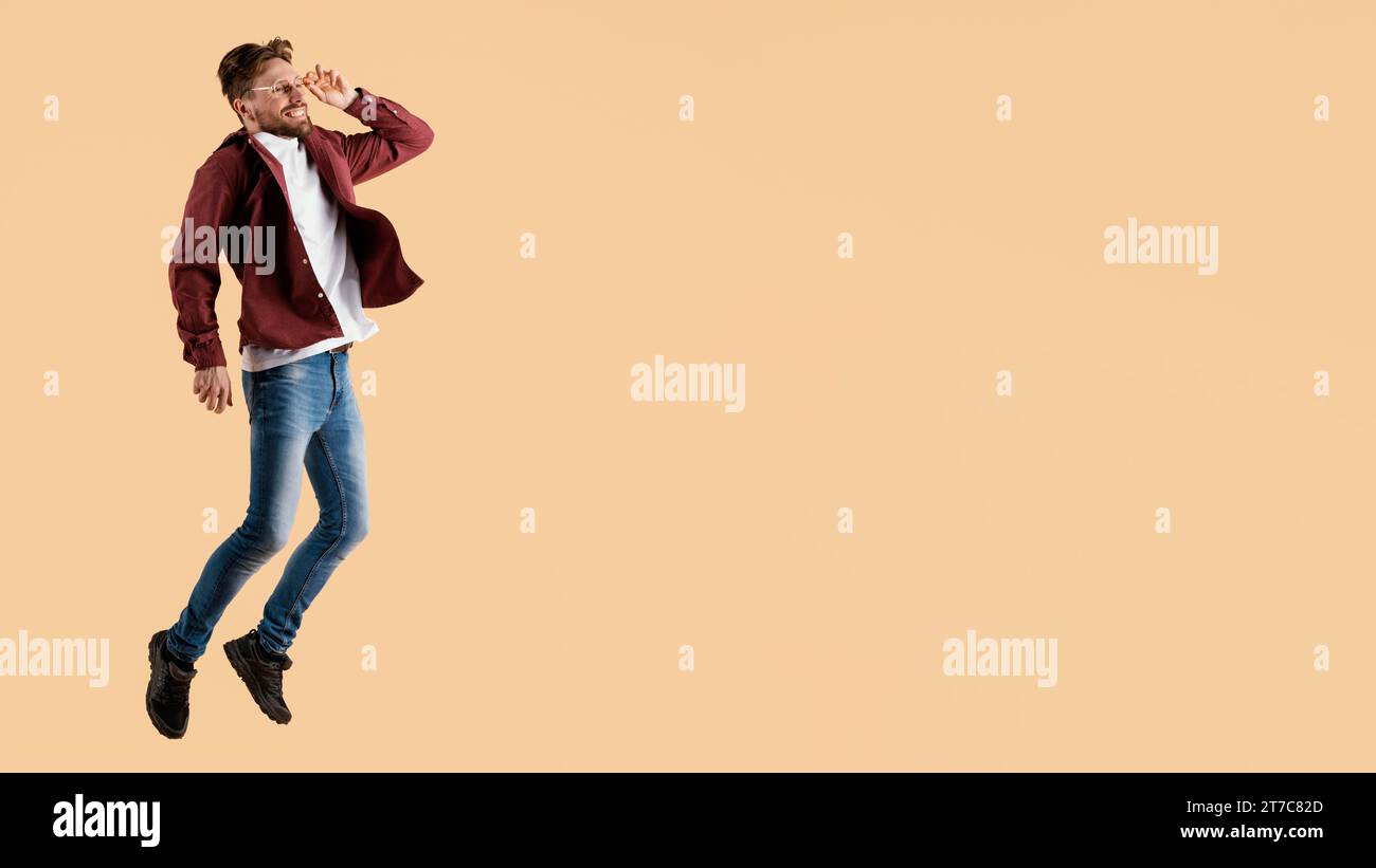 Side view young handsome man jumping Stock Photo - Alamy