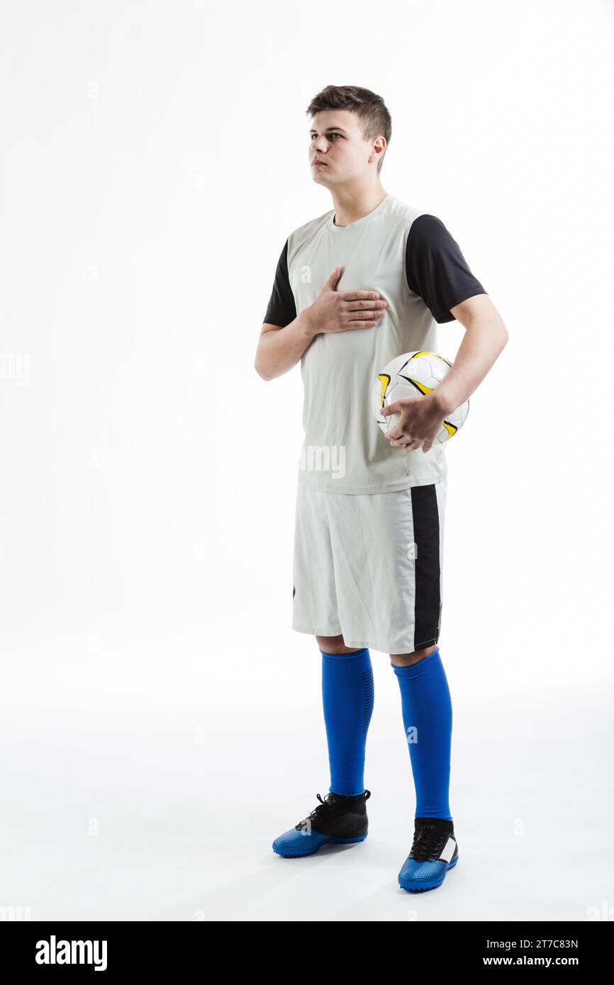 Soccer player with one hand chest Stock Photo - Alamy