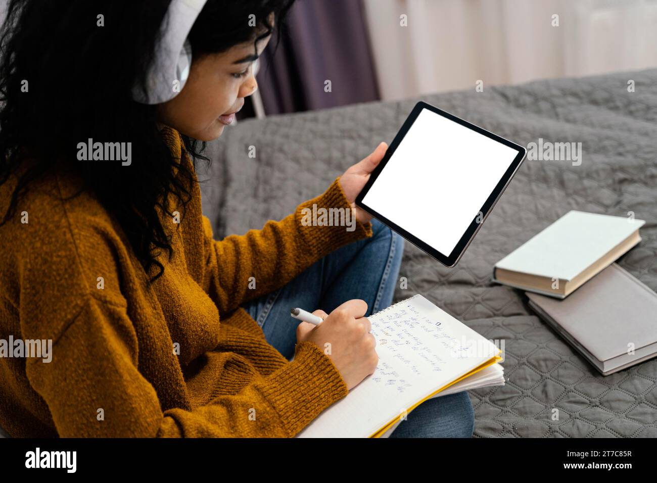Teenage girl using tablet online school Stock Photo - Alamy