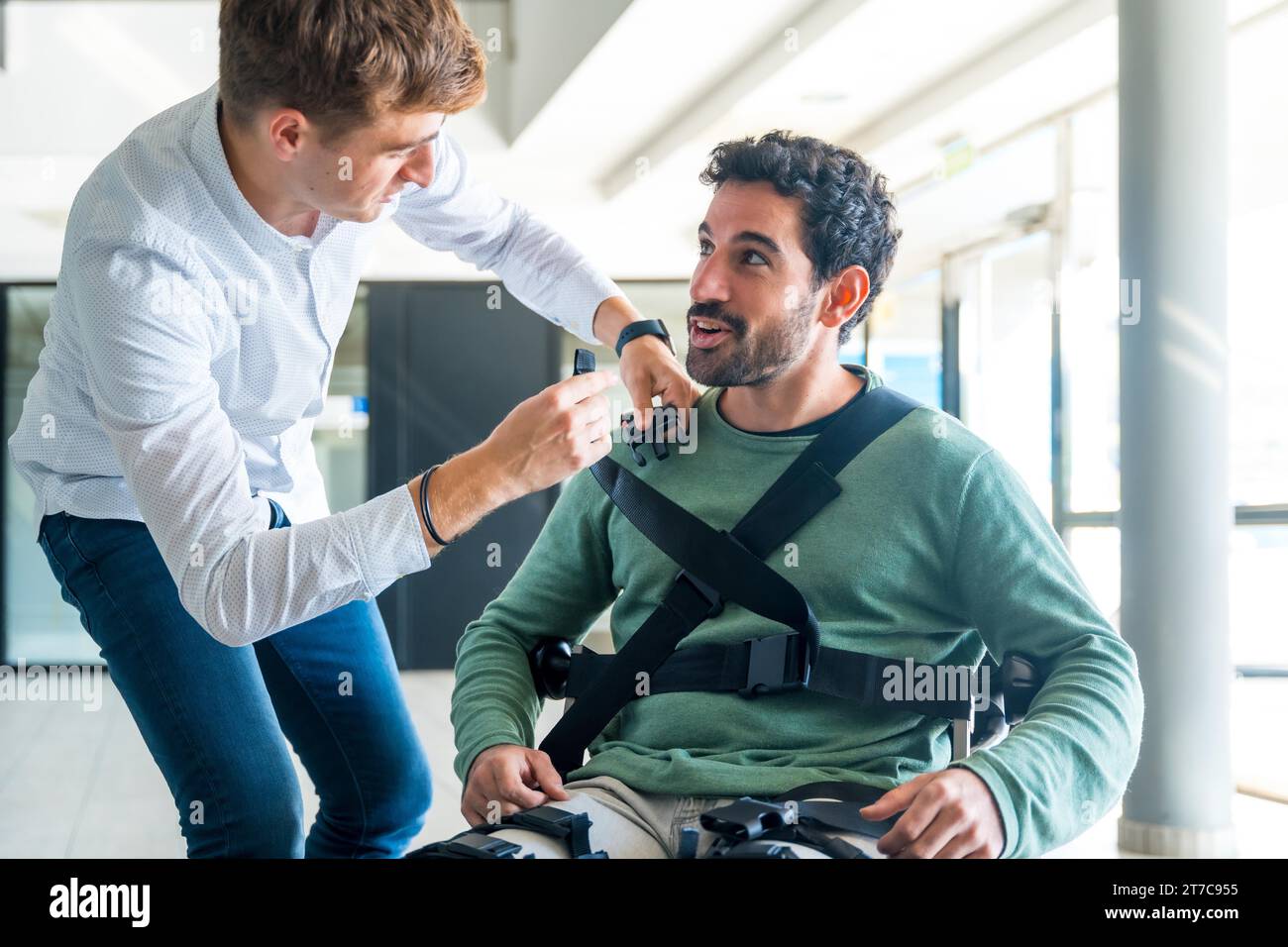 Mechanical exoskeleton, physiotherapist placing the tapes on the chest ...