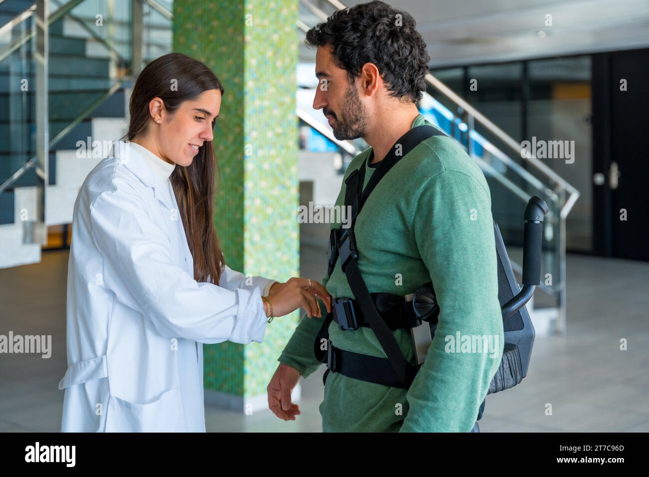 Doctor putting robotic exoskeleton disabled hi-res stock photography ...