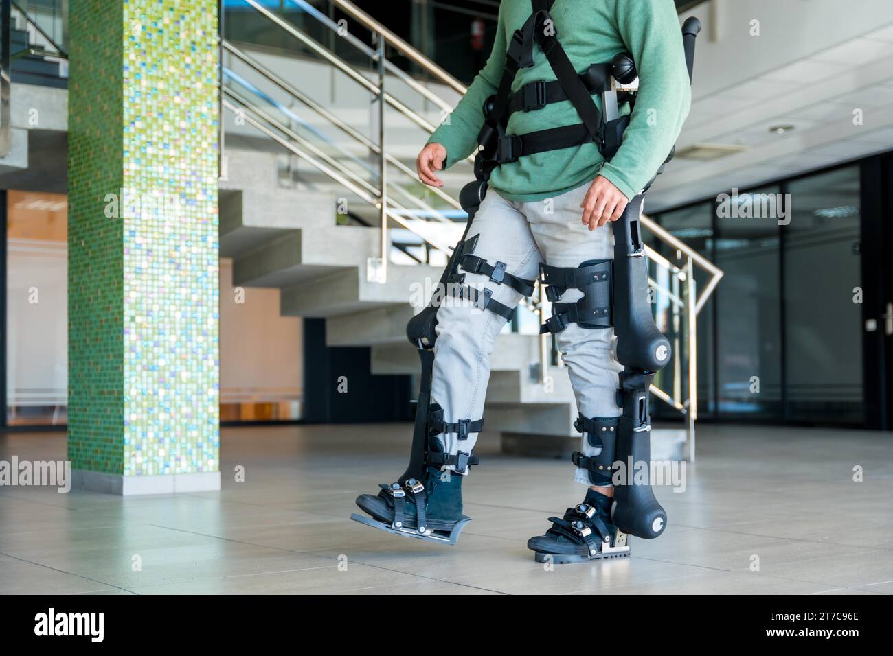 Mechanical exoskeleton, unrecognizable disabled person walking with the ...