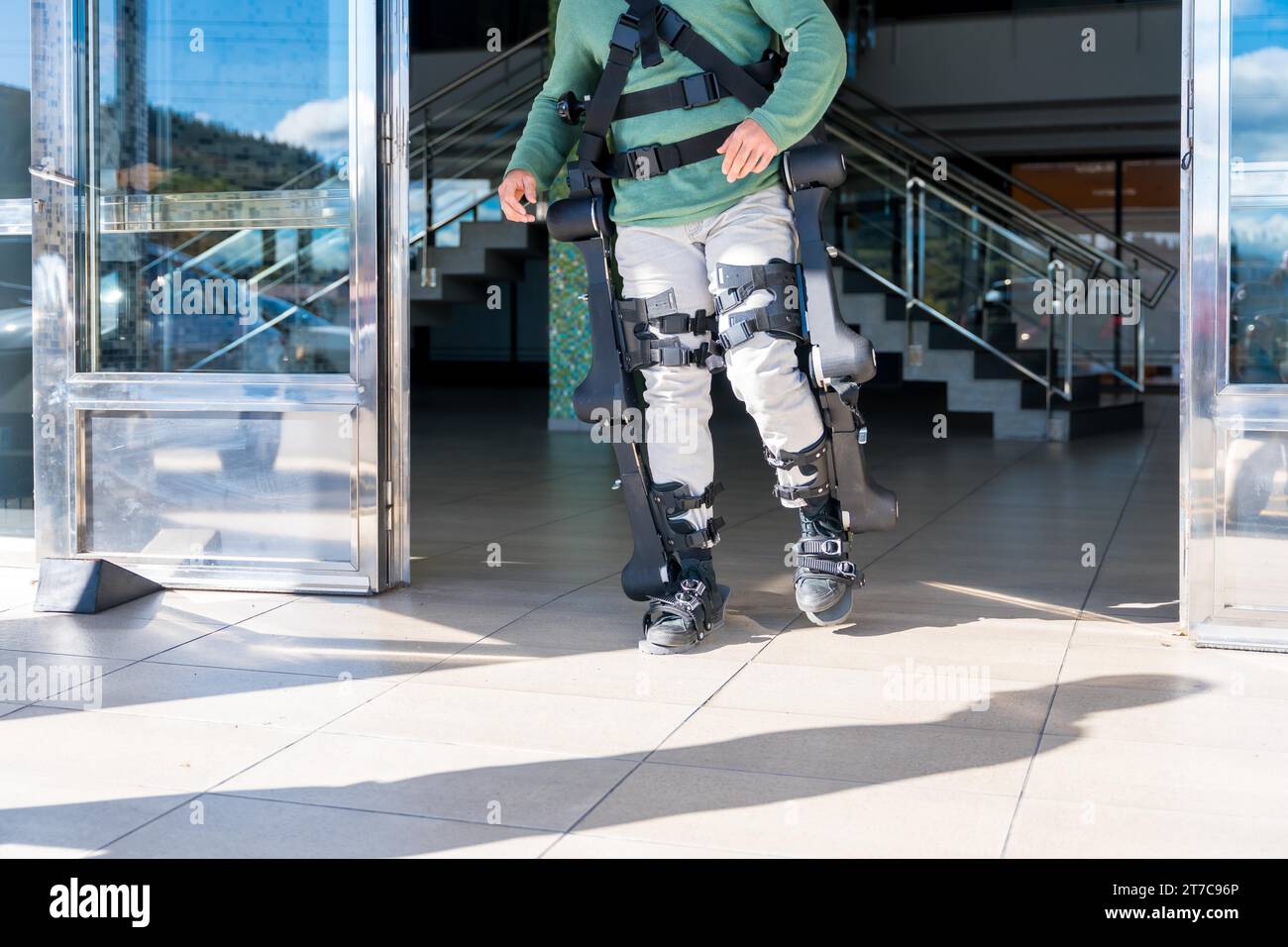 Mechanical exoskeleton, disabled person walking with the help of ...