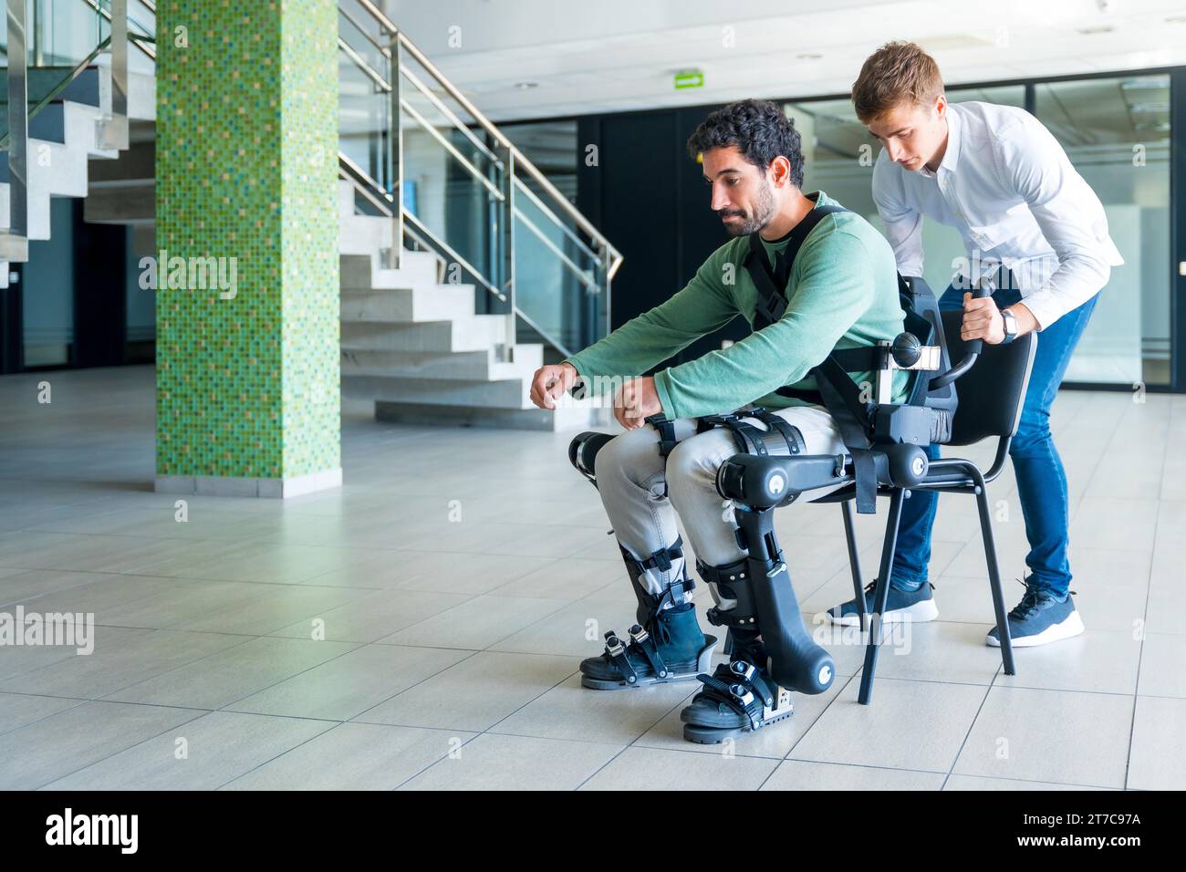 Mechanical exoskeleton, physiotherapist helped disabled person get up ...
