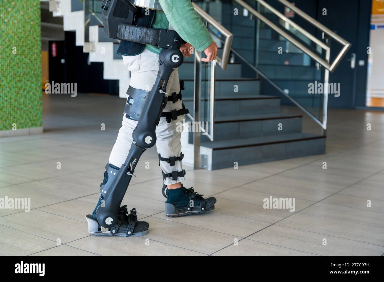 Mechanical exoskeleton, unrecognizable disabled person walking with the ...