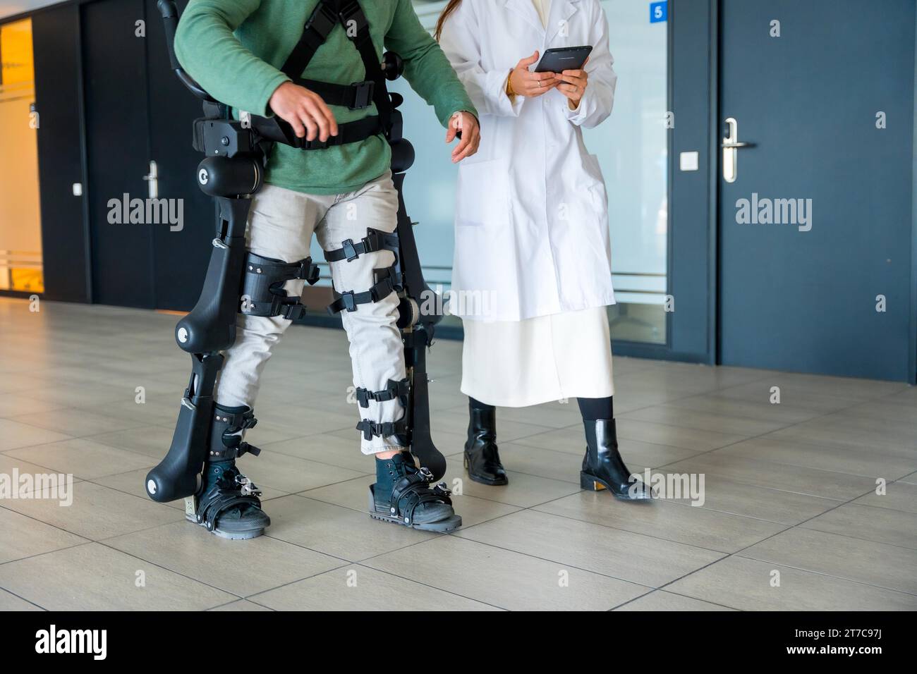 Mechanical exoskeleton, female doctor physiotherapist with ...