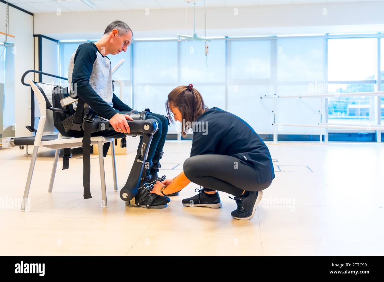 Mechanical exoskeleton. Physiotherapy in a modern hospital: Female ...