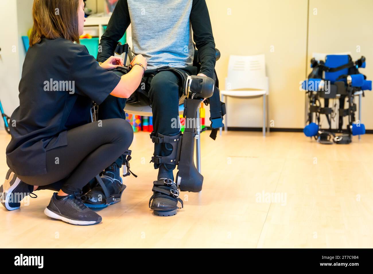 Mechanical exoskeleton. Physiotherapy in a modern hospital: Female ...