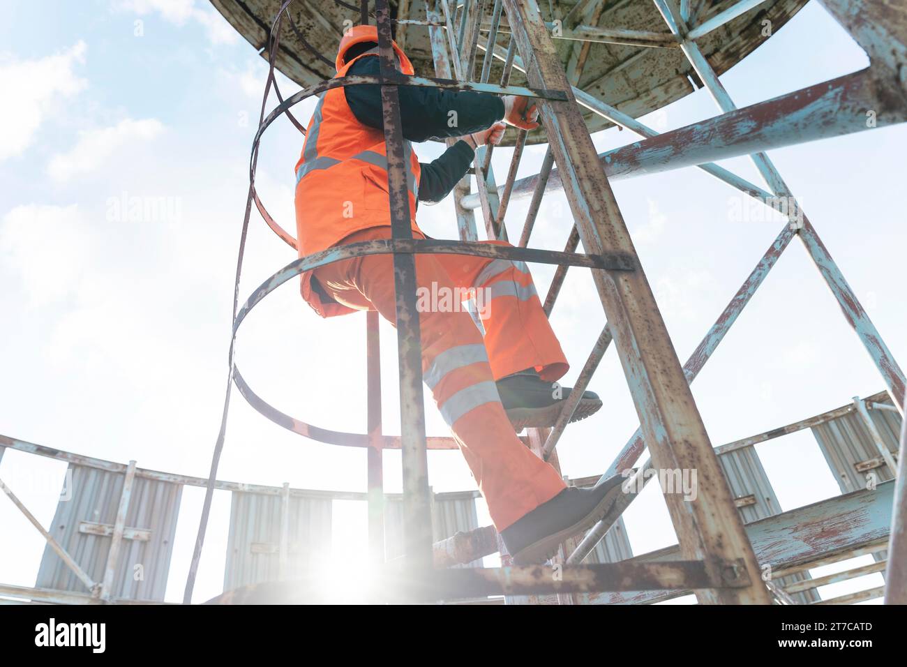 Full shot man with safety equipment ladder Stock Photo - Alamy