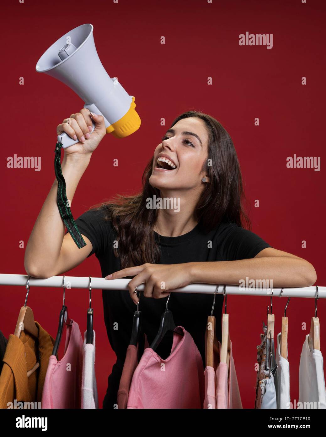 Happy woman shouting through megaphone Stock Photo - Alamy