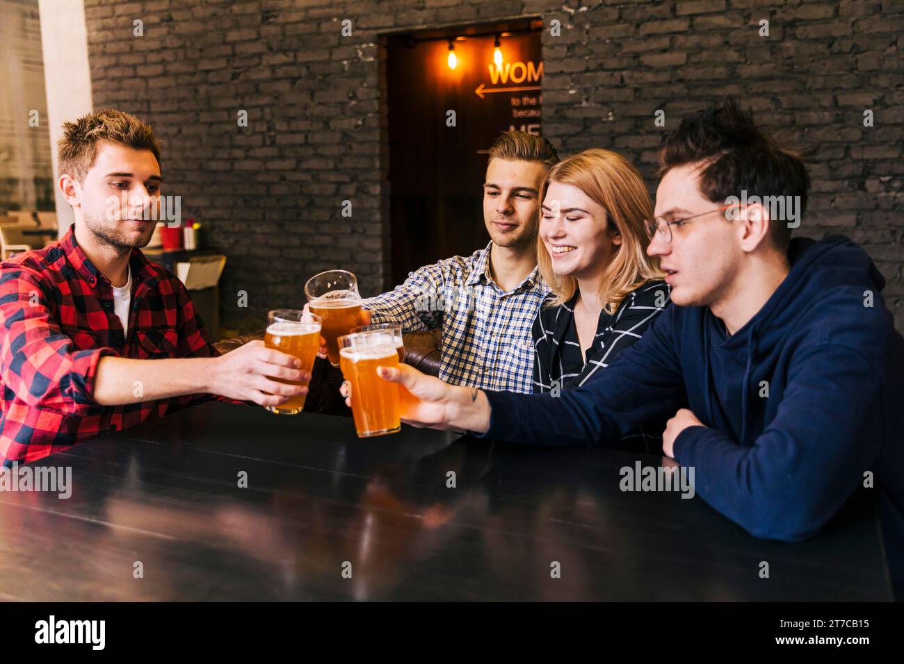 Group young people cheering bar restaurant Stock Photo - Alamy