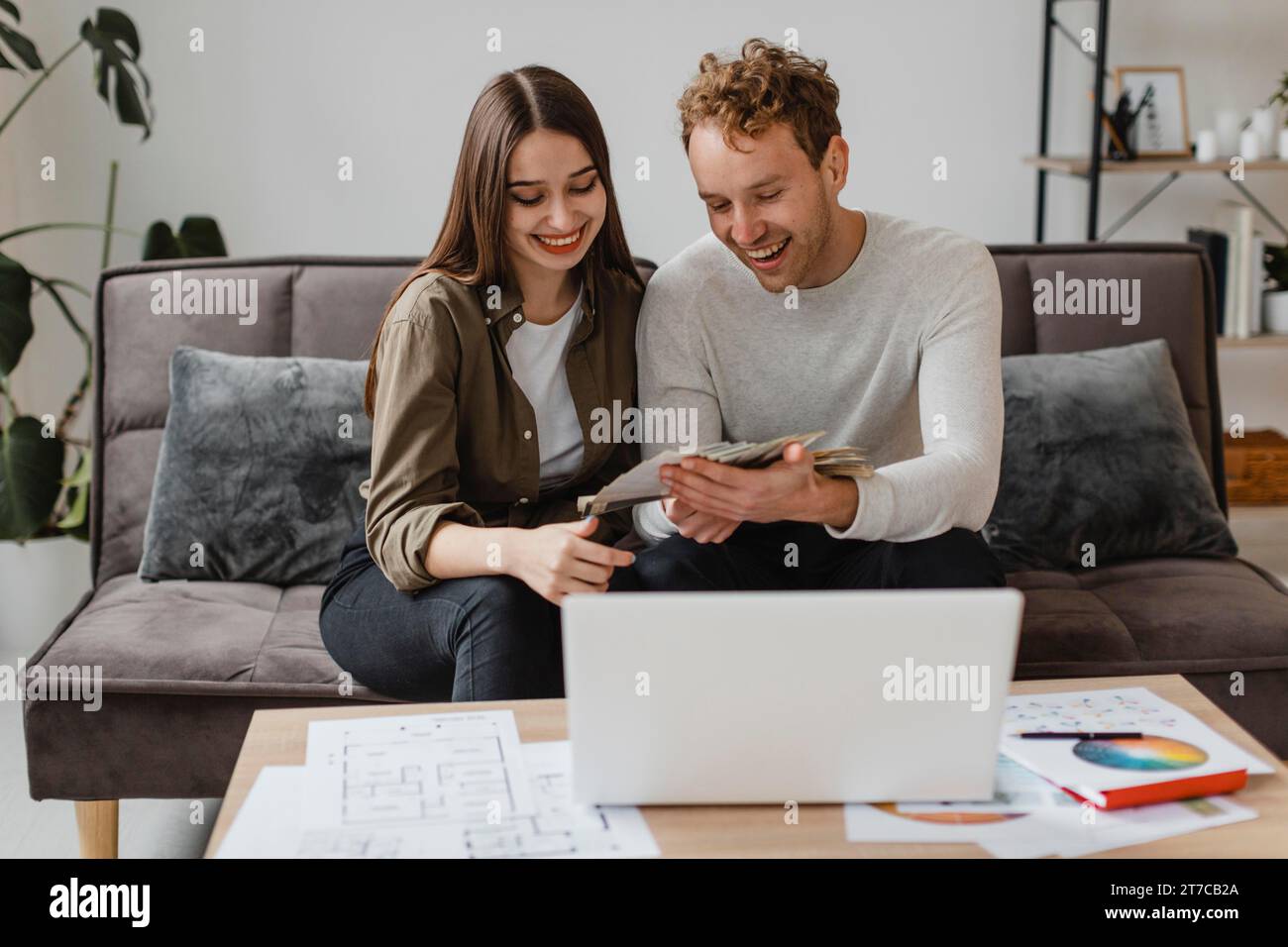 Happy couple making plans remodel home together Stock Photo - Alamy