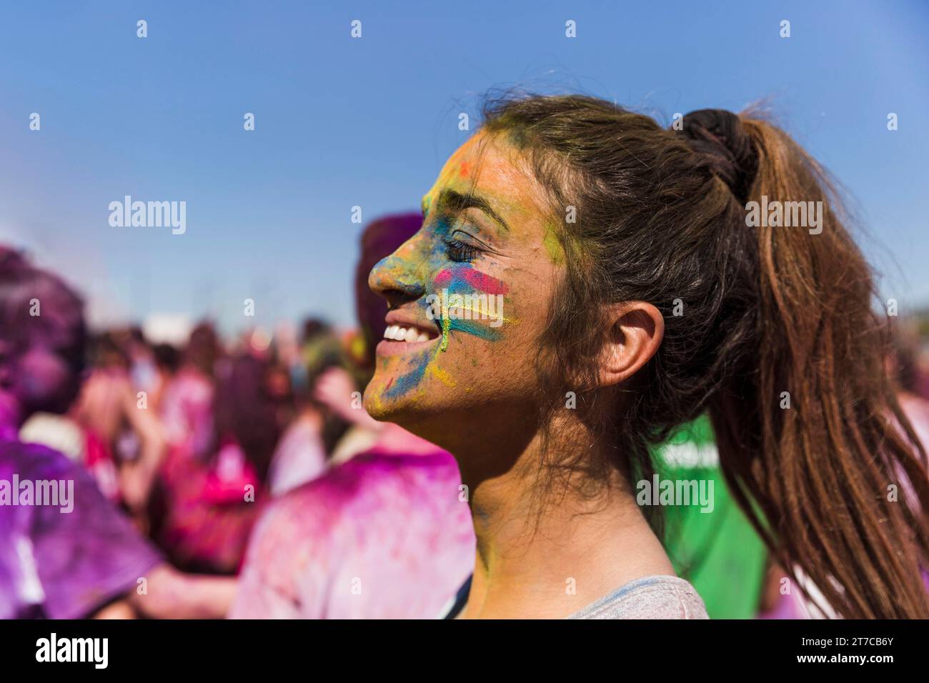 Holi color woman s face front crowd Stock Photo - Alamy