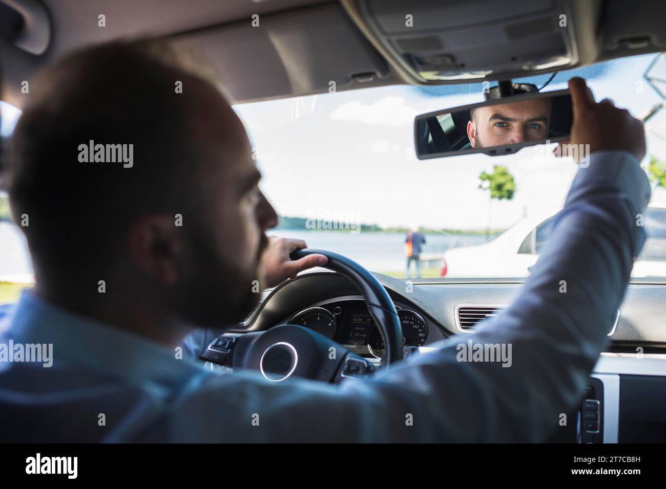 Male driver adjusting car s rear view mirror Stock Photo - Alamy
