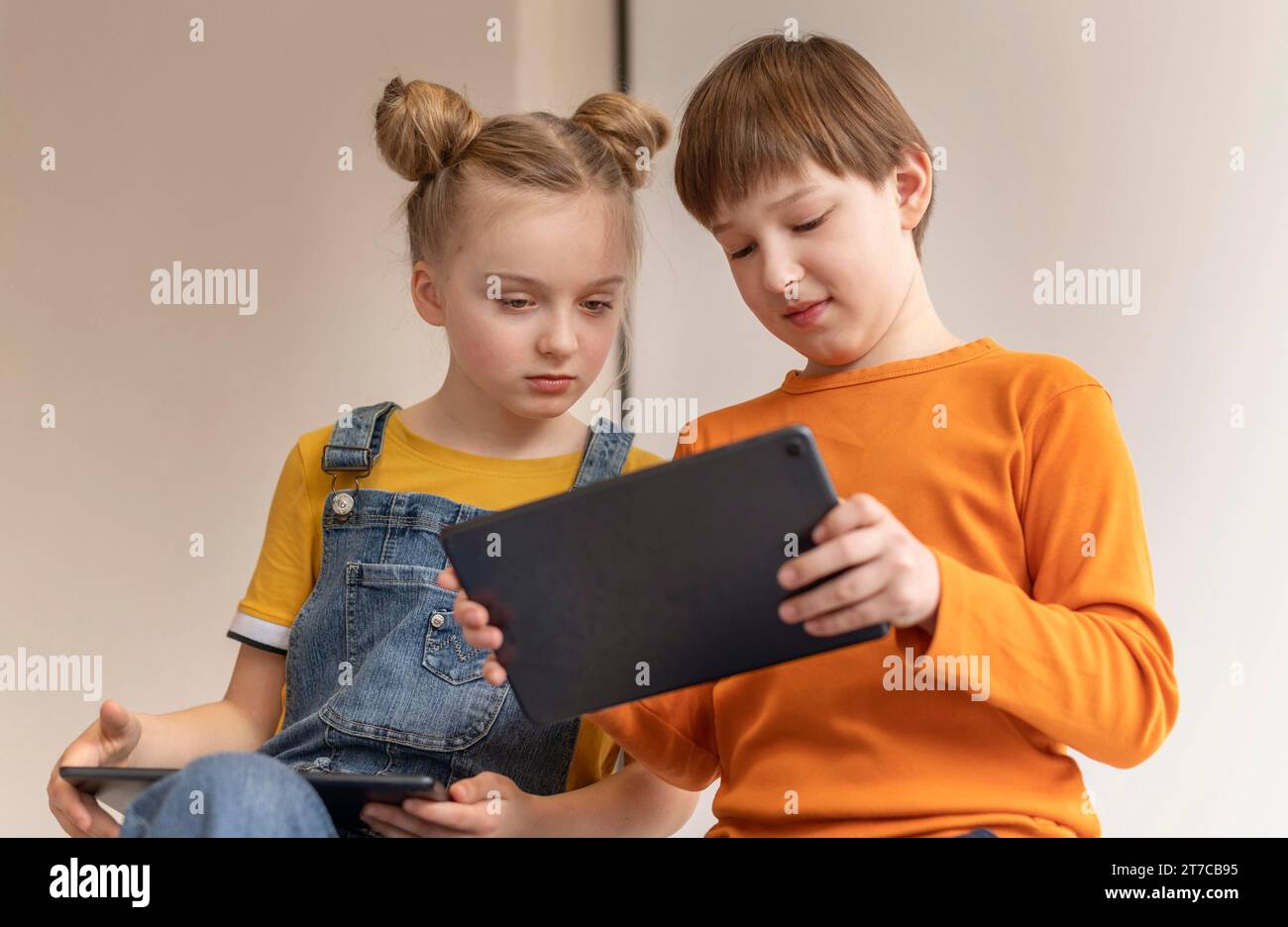 Low angle kids learning with devices Stock Photo - Alamy
