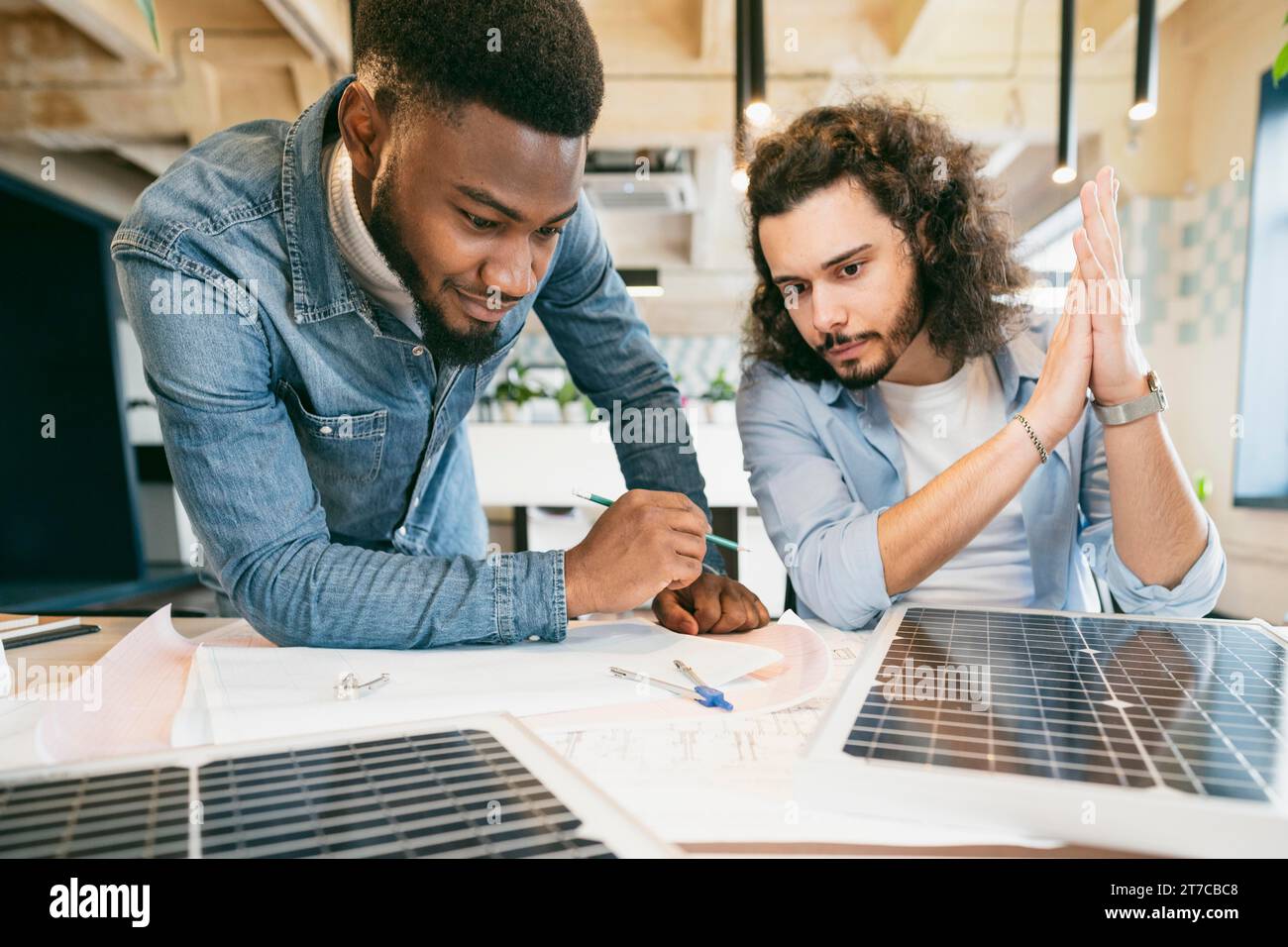 Medium shot men working project Stock Photo - Alamy