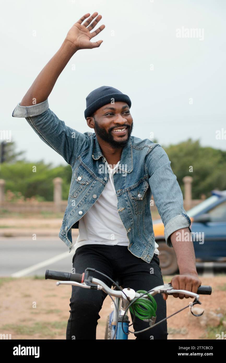 Medium shot smiley man waving Stock Photo - Alamy
