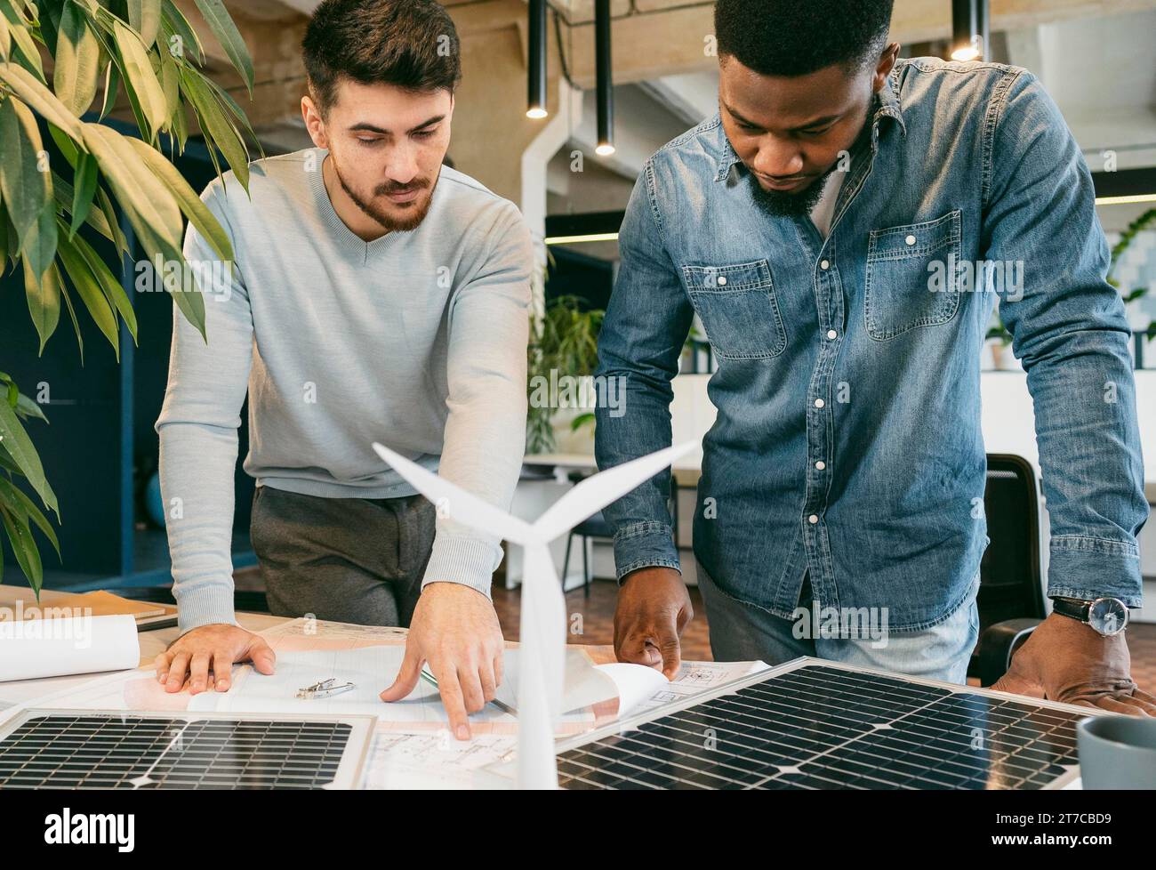 Medium shot men working together Stock Photo - Alamy