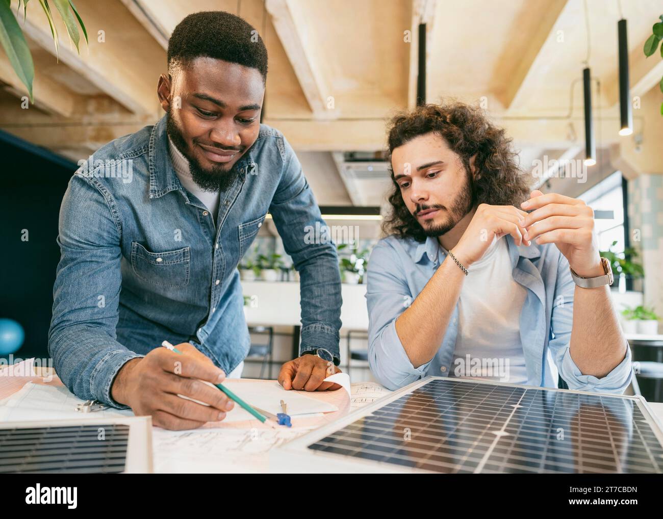 Medium shot men working project together Stock Photo - Alamy