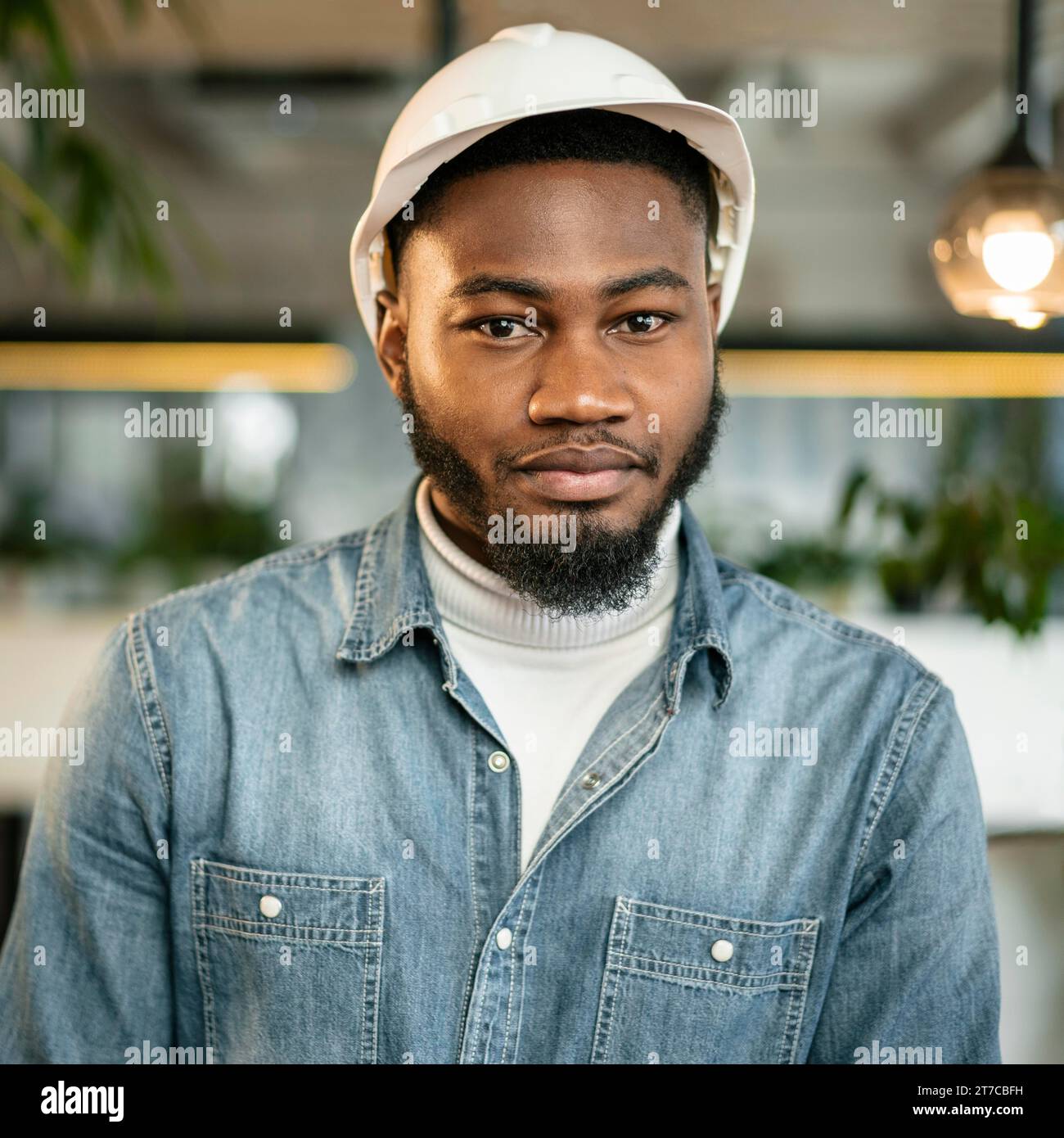 Medium shot man posing with helmet Stock Photo - Alamy