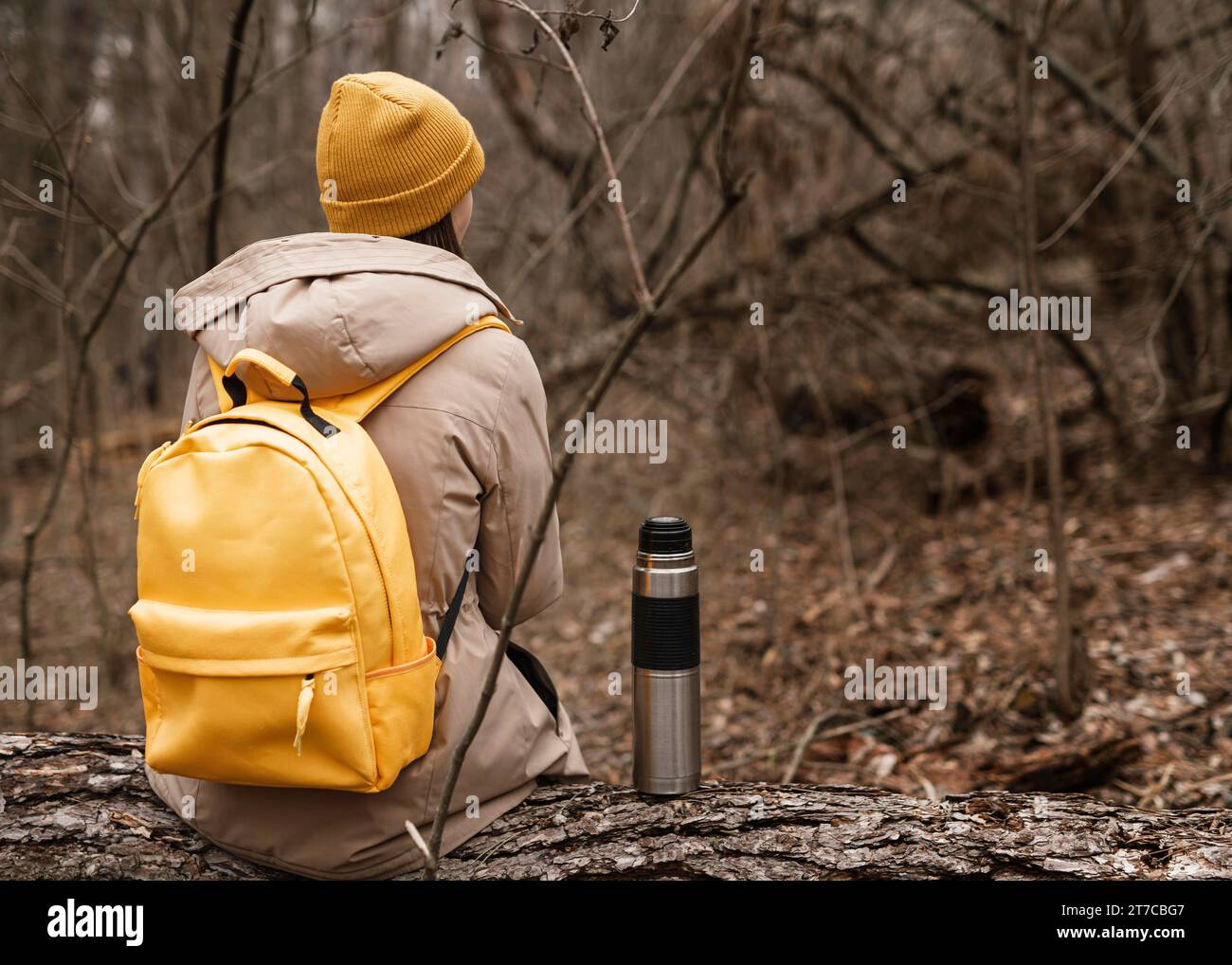Medium shot woman sitting log Stock Photo - Alamy