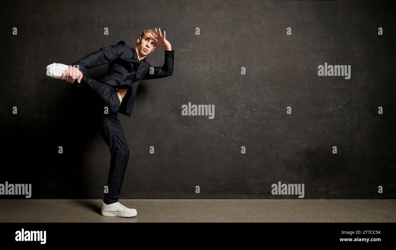 Side view male performer suit posing with copy space Stock Photo - Alamy