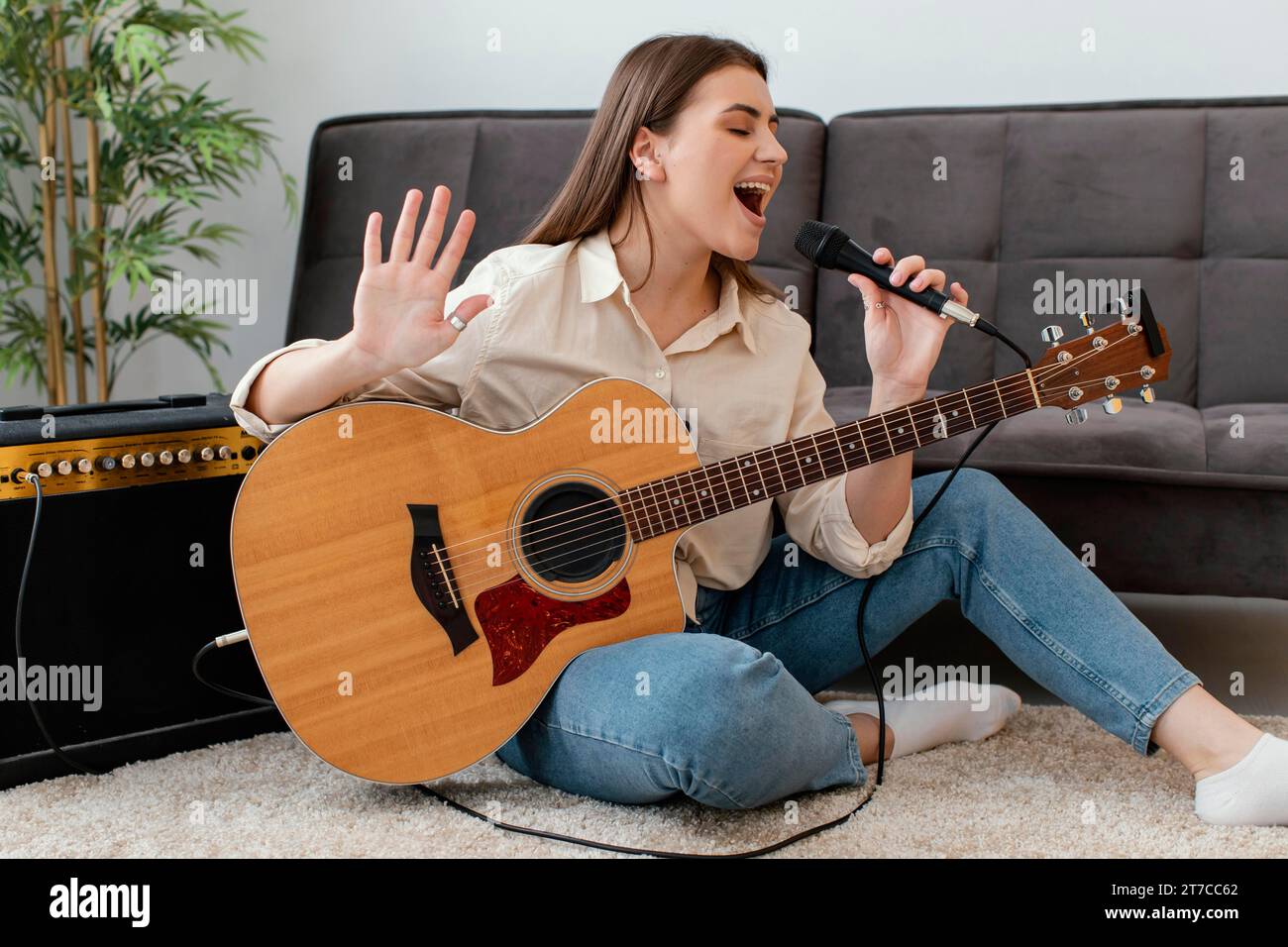 Smiley female musician playing acoustic guitar singing microphone Stock ...