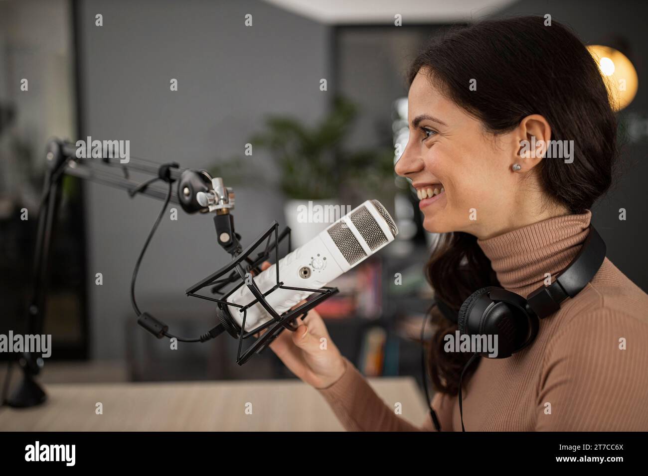 Side view smiley woman doing radio Stock Photo - Alamy