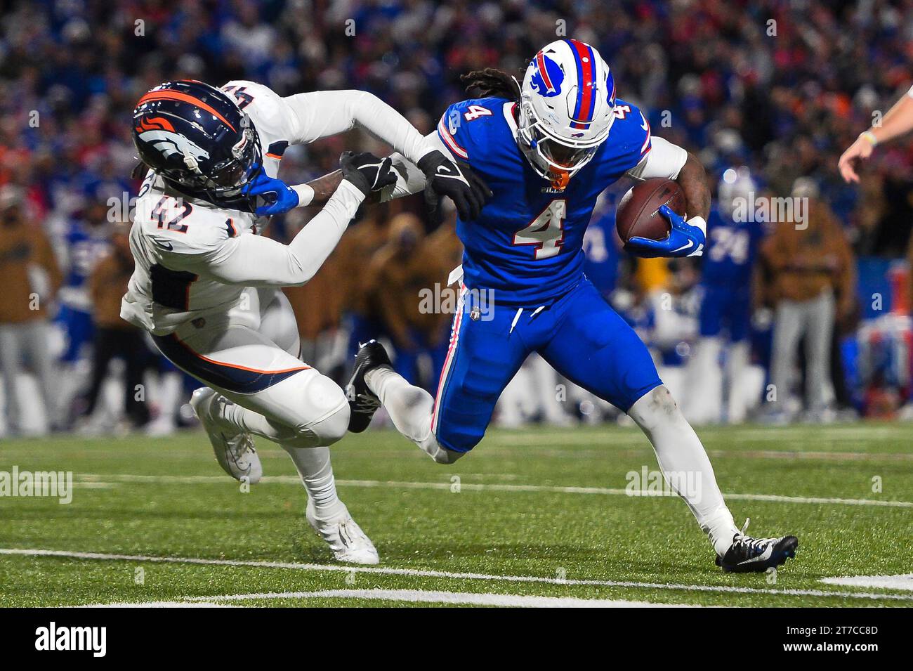 Buffalo Bills running back James Cook, right, stiff arms Denver Broncos ...