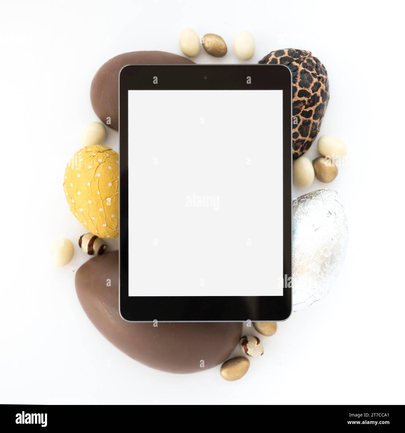 Tablet with blank screen chocolate easter eggs Stock Photo - Alamy