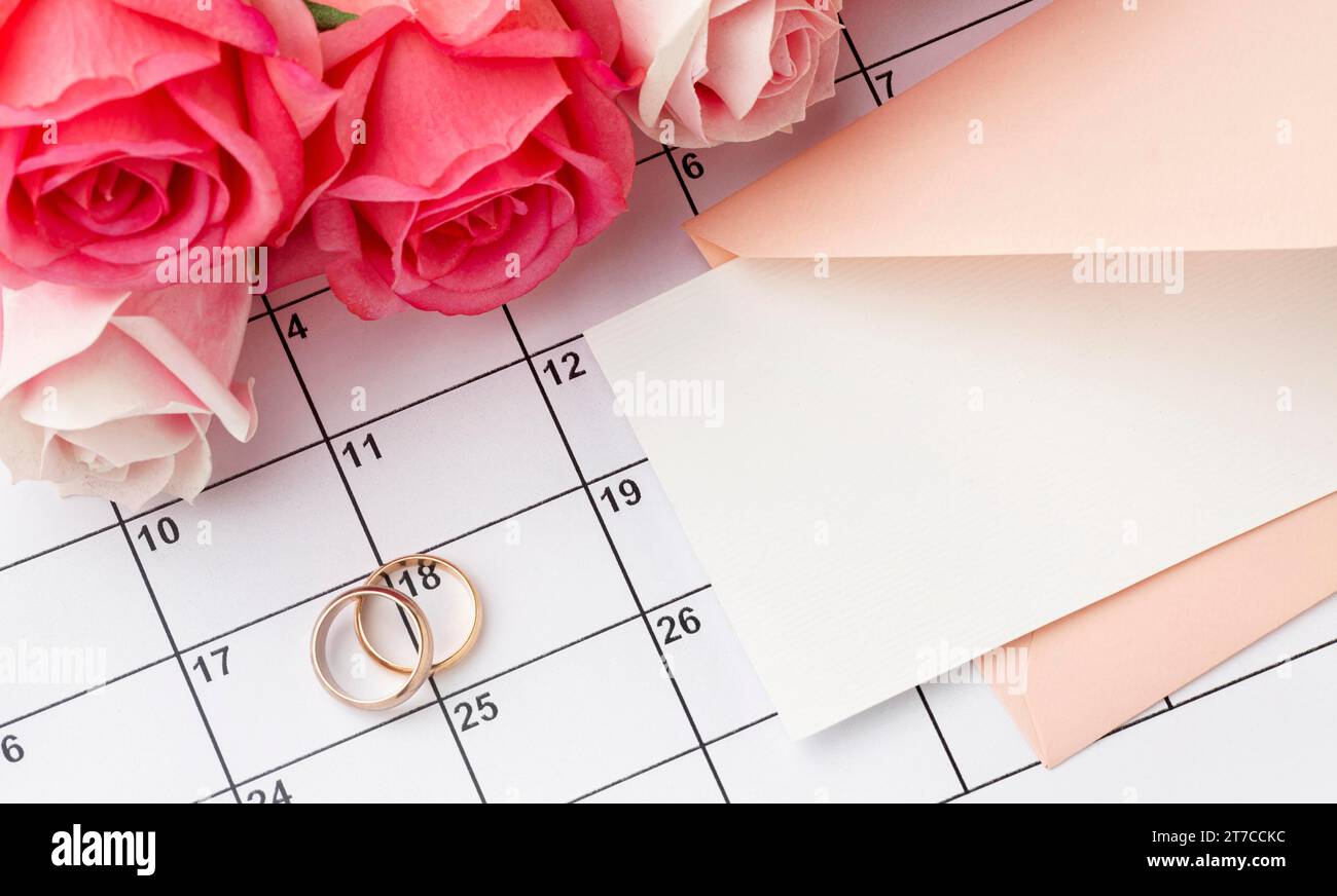 Wedding rings with flowers calendar Stock Photo - Alamy