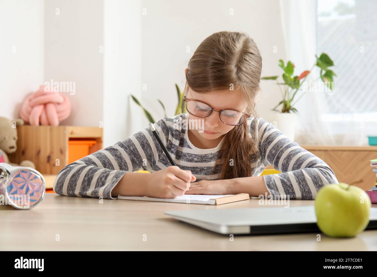Little girl doing lessons at home Stock Photo - Alamy