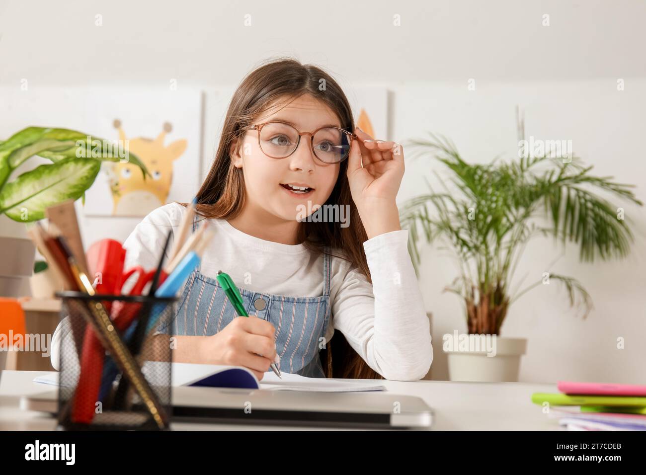 Little girl doing lessons at home Stock Photo - Alamy